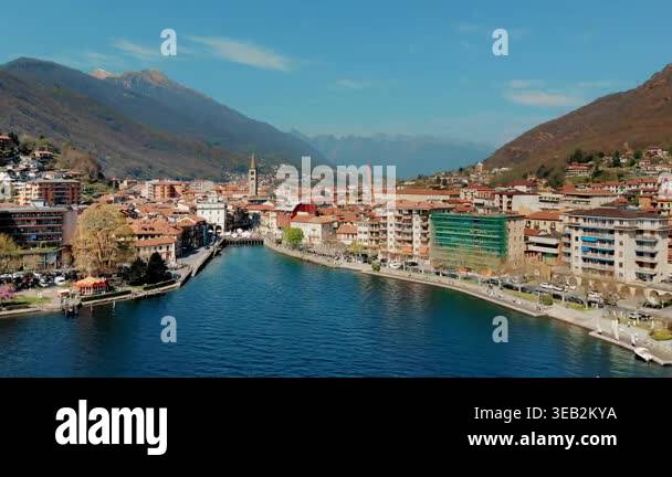 Wide drone panorama of scenic Italian lake resort framed by alpine ...