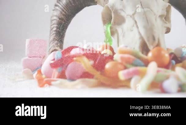 Mist drifting, green goo oozing from skull onto candies, pulsing dot ...