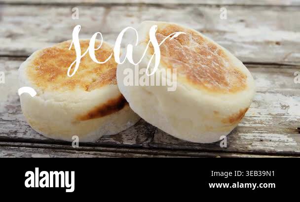 Toasted muffins on rustic table with holly leaves and season's ...