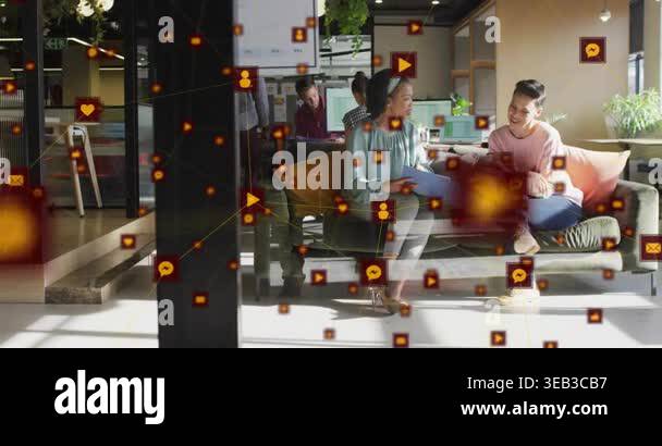 Women collaborating on business task in office tapping screens, glowing ...