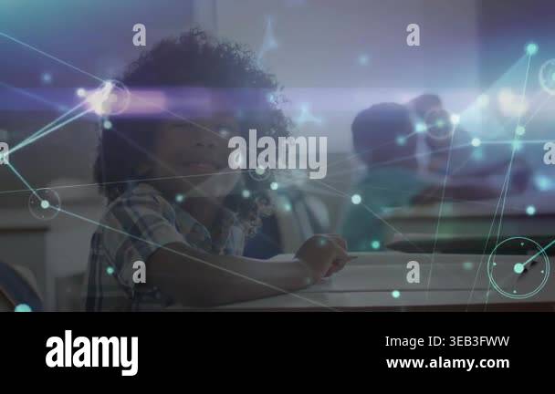 Boy lifting head in classroom and initiating semi transparent network ...