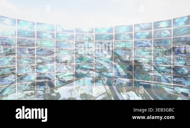 Curved wall of digital screens displaying cityscape and binary code ...