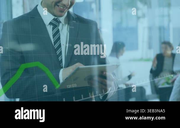 A businessman smiling and using a digital tablet in an office. Global ...