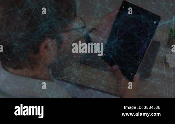 Animation of network of connections over caucasian man using tablet ...