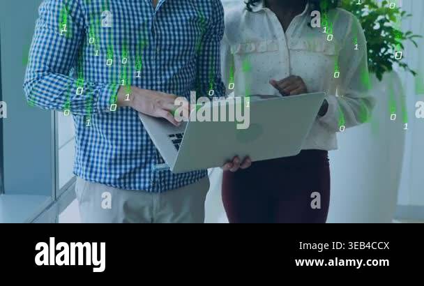 Man typing on laptop and woman pointing at screen while green binary ...