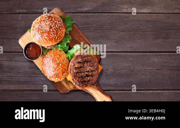 Summer BBQ food table scene with hot dog and hamburger buffet. Stop ...