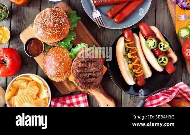 Summer BBQ food table scene with hot dog and hamburger buffet. Slow ...