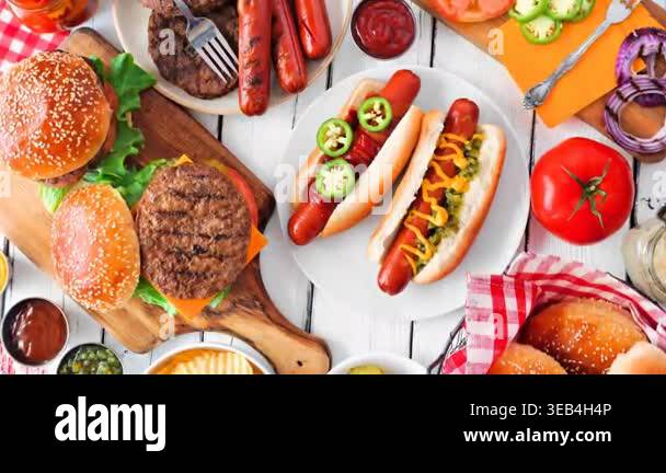 Summer BBQ food table scene with hot dog and hamburger buffet. Slow ...