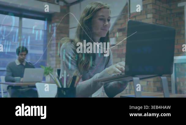 Woman typing on elevated laptop in office, causing animated finance ...
