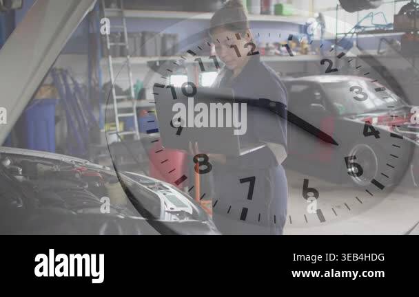 Female mechanic consulting laptop and diagnosing engine in auto garage ...