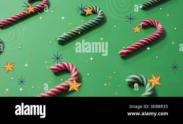 Animation of stars over candy canes on green backrgound. Christmas ...
