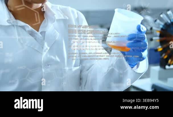 Lab pro raising beaker to light, rotating and testing orange sample ...