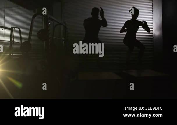 Animation of man and woman exercising together in gym with glowing ...
