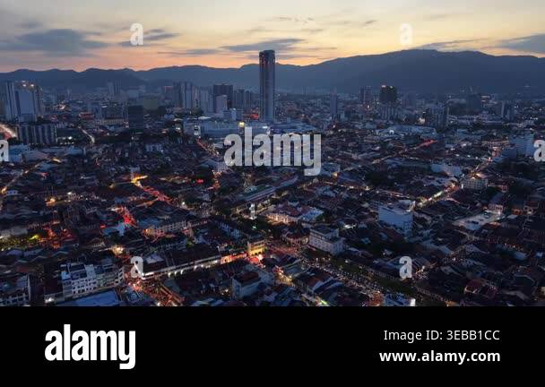 Dusk aerial of Penang city streets lit with lanterns during Miaohui ...