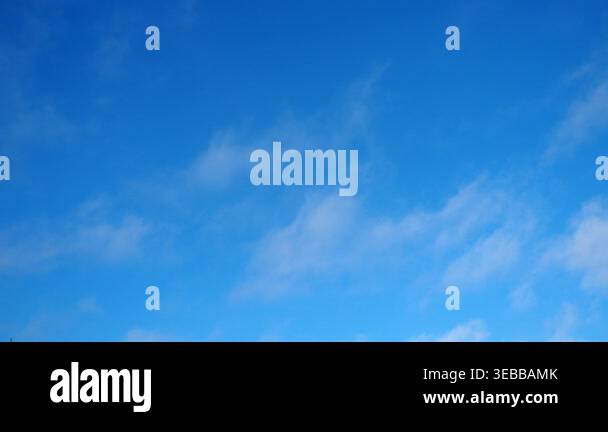 The sky shows a deep blue color with white clouds. Clouds drift quietly ...