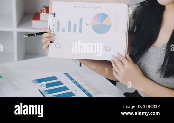 woman hand writing on a chart with calculator on a table. business and ...