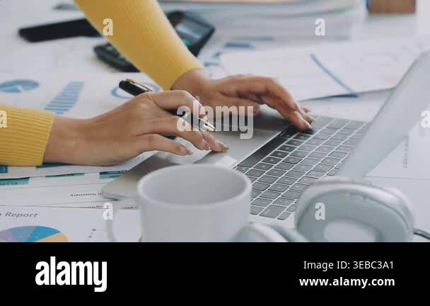 businesswoman analyzing financial charts and using computer in the ...