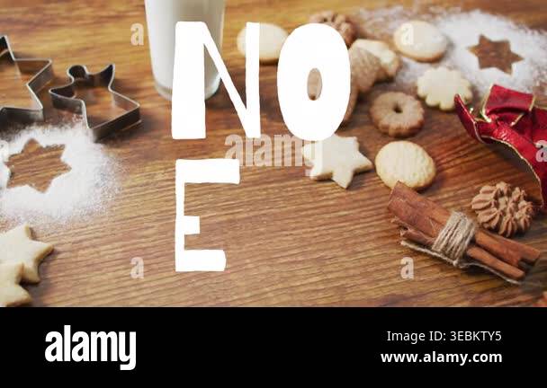 Animation of noel text over christmas cookies and decorations on wooden ...