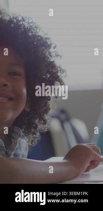 Vertical video: Boy with pencil at desk, charts animating from left ...