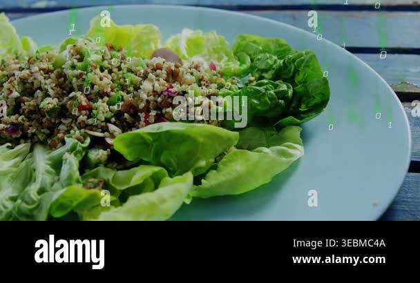 Binary digits starting two-second frame cascading over quinoa salad on ...