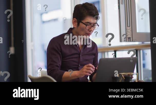 Animation of question marks over asian businessman working at office ...