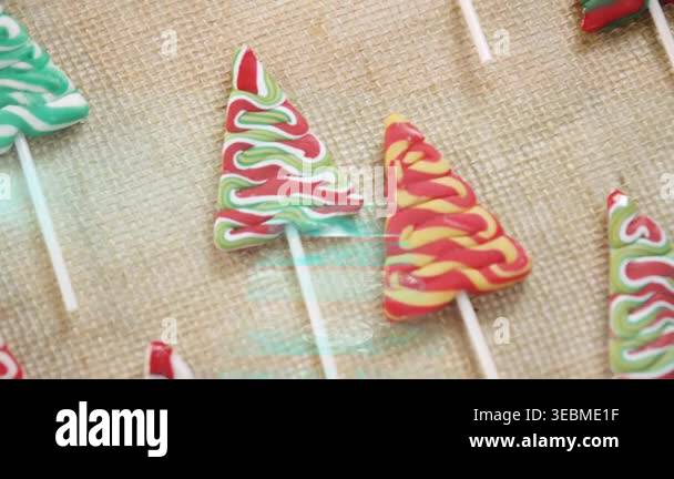 Animation of light moving over christmas tree lollipops on fabric ...