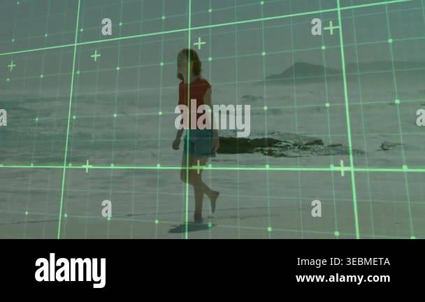 Playing on beach, child interacting with digital grid overlay animation ...