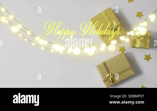 Animation of happy holidays text with fairy lights over presents ...