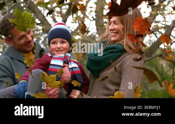 Animation of falling leaves over happy caucasian father and mother ...