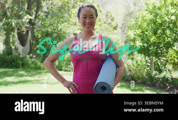 Yoga instructor holding mat on garden lawn reacting to neon Sign Up ...