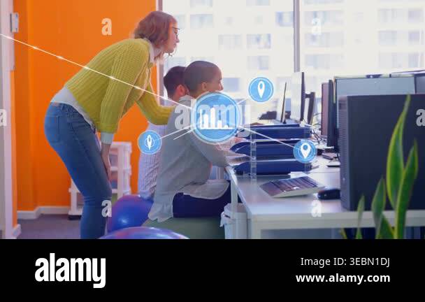 Mentor leaning over team guiding typing in business, blue network icons ...