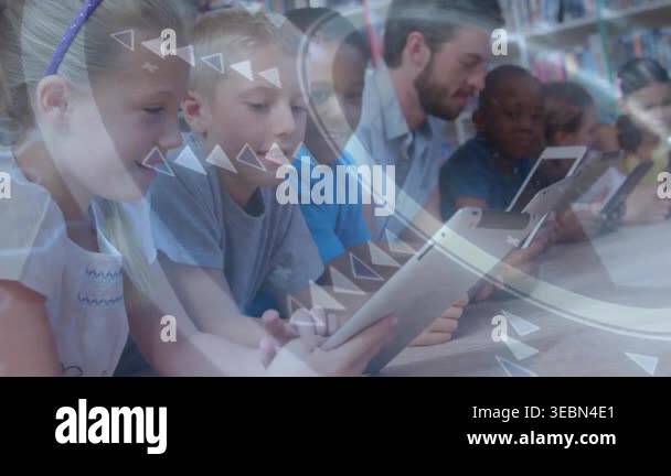 Students tapping tablets for lesson in class teacher checking screens ...