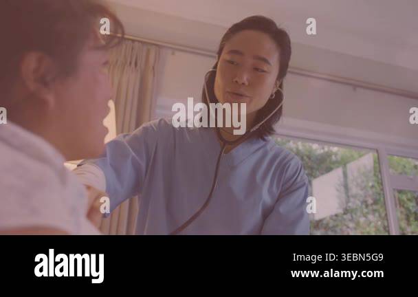 Animation of light spots over asian doctor and patient. Global medicine ...