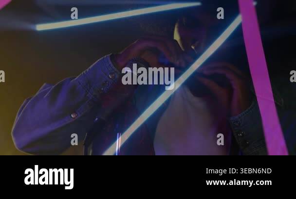Singer leaning to mic, forming heart sign with music pulsing as neon ...