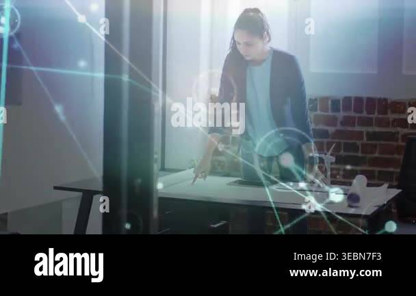 Animation of network of connections over businesswoman working in ...