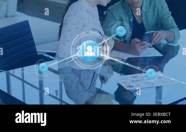 Man tapping phone and woman viewing charts at glass table expanding ...