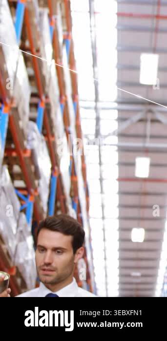Vertical video: Lead walking depot examining can for audit as rep ...