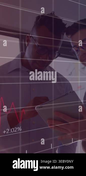 Vertical video: Two men tapping tablet causing live finance graphs ...