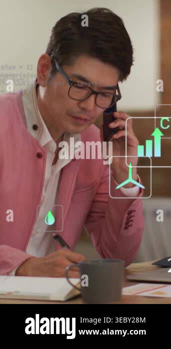 Vertical video: Exec answering call, taking notes on ESG while chart ...