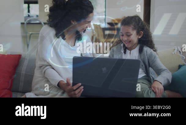 Mother guiding daughter on sofa, opening laptop and causing animated ...