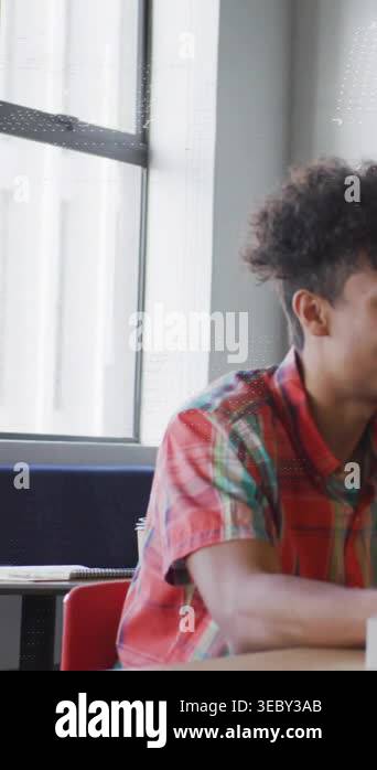 Vertical video: Student responding to offscreen cue, gesturing to notes ...