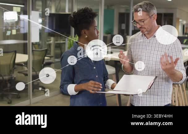 Man explaining, woman reviewing clipboard, icon appearing, business ...