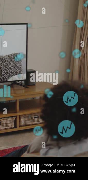 Vertical video: Boy on rug watching TV, blue data icons drifting from ...