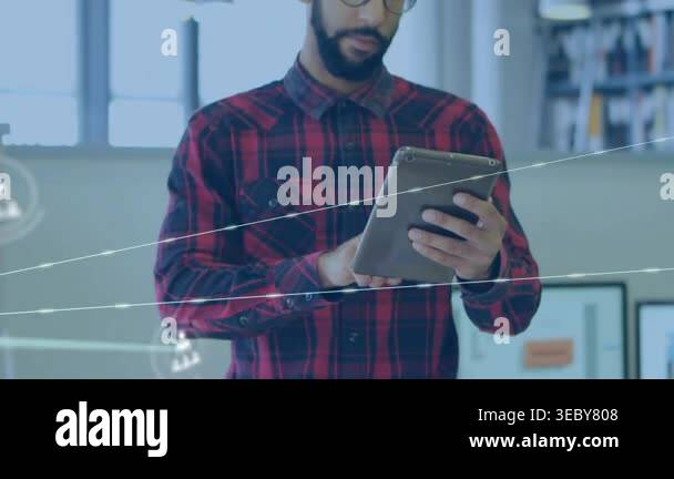Man tapping tablet, activating network overlay with icons while mapping ...