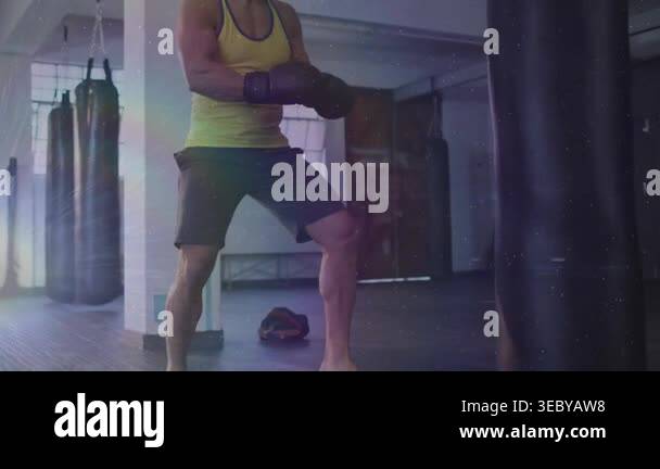 Male boxer shifting stance, drilling jabs and hooks on heavy bag ...