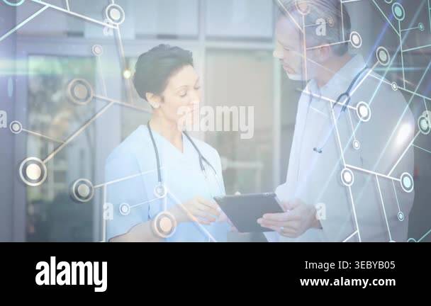 Nurse and doctor reviewing tablet, confirming patient plan, handshaking ...
