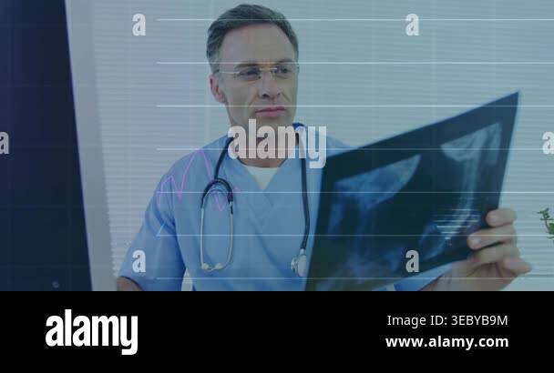 Dr reviewing monitor while holding and rotating X-ray, animated graphs ...