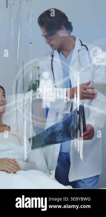 Vertical video: Dr showing X-ray to her while nurse joins with tablet ...