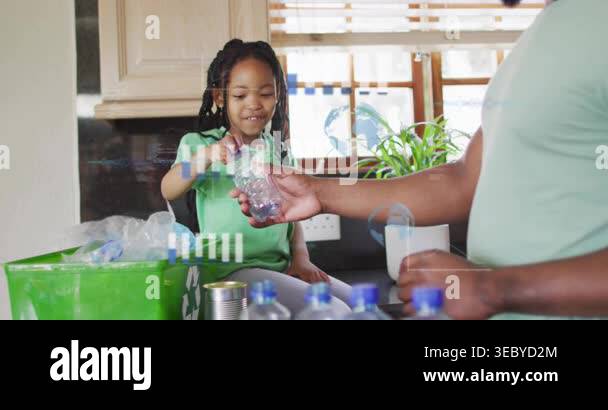 Daughter handing bottle to father at kitchen counter, starting ...
