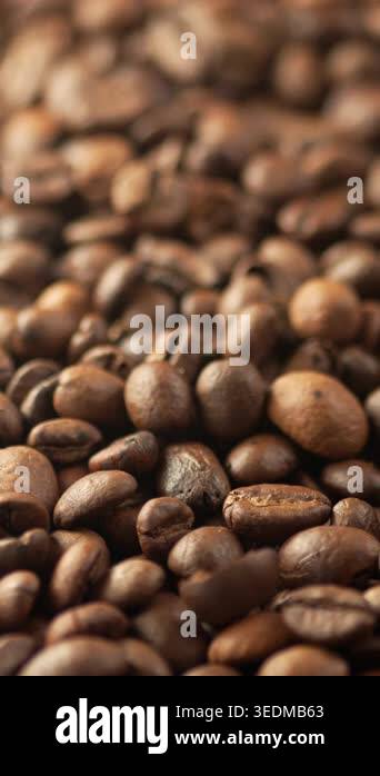 Close-up of coffee beans falling, rich texture and aroma. roasted beans ...